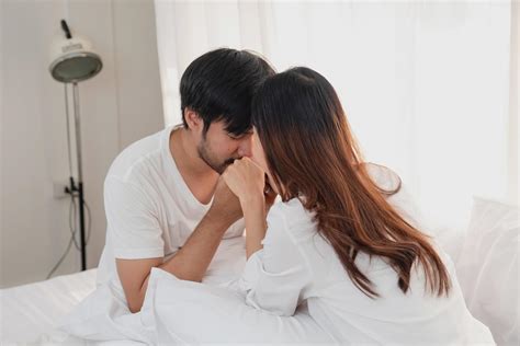 Happy Young Asian Couple Embracing Teasing Playing Cheerfully In Bed At Home Romantic Time To