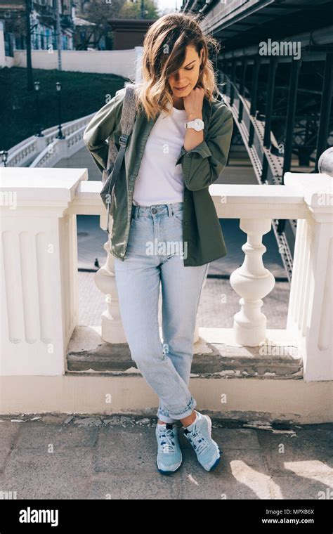 Fashionable Young Woman Posing Near City Bridge In Casual Outfit At Sunny Day Girl With