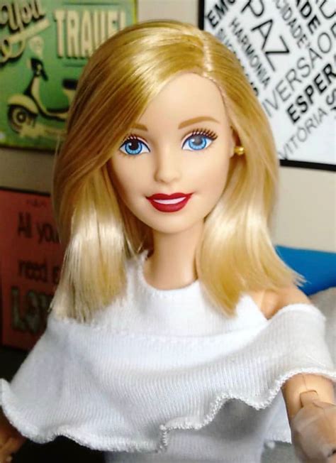 A Barbie Doll With Blonde Hair And Blue Eyes
