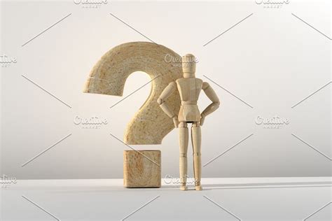 A Wooden Figure Standing Next To A Block Of Wood That Is Shaped Like A