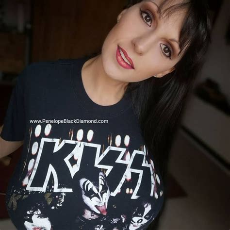 A Woman With Long Black Hair Posing For The Camera