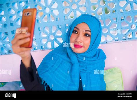 Lifestyle Portrait Of Young Happy And Beautiful Tourist Woman In Muslim Hijab Head Scarf Taking