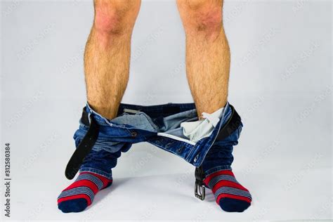Man Has His Pants And Underwear Down At The Anklesman In Front Of White Background Has Pants