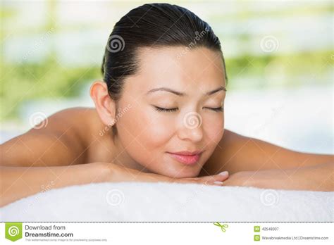Smiling Brunette Lying On Massage Table With Eyes Closed Stock Image Image Of Young Adult
