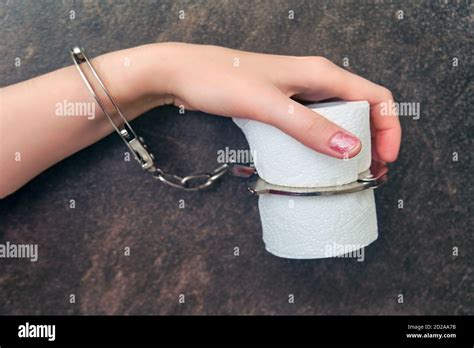 Female Hand Handcuffed To Toilet Paper Close Up Concept Of Abdominal