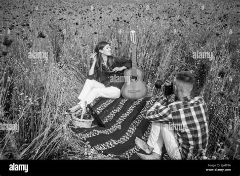 Couple In Love Making Photo On Camera With Acoustic Guitar In Summer Poppy Flower Field Free