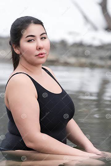 Young Busty Curvy Full Figured Young Model In Black Swimsuit Sitting In Outdoors Pool At Spa