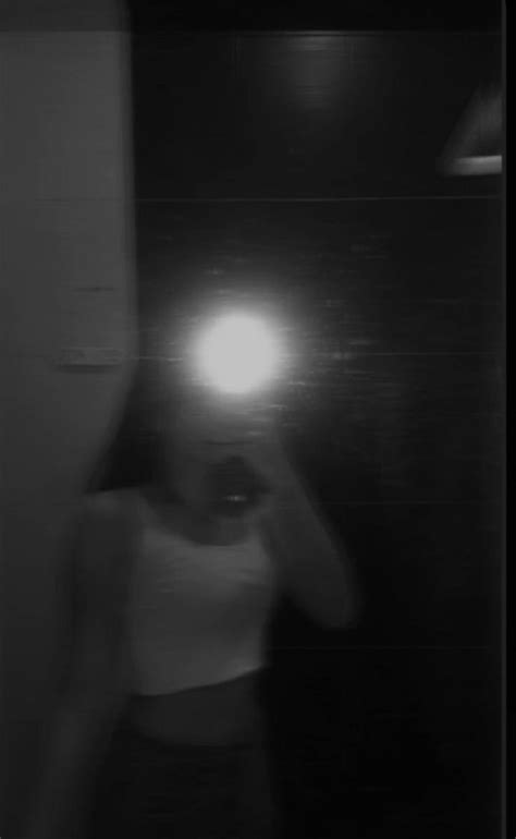A Woman Taking A Selfie In The Mirror
