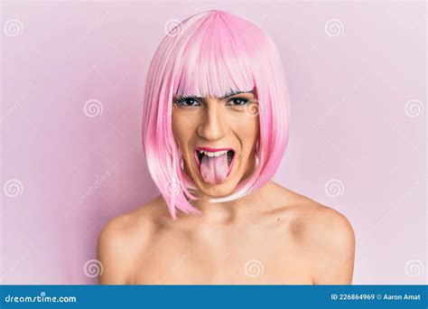 Young Man Wearing Woman Make Up Wearing Pink Wig Sticking Tongue Out Happy With Funny Expression