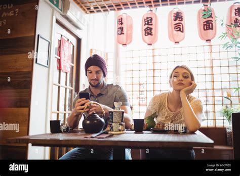 Man Ignoring Woman While Using Mobile Phone Stock Photo Alamy