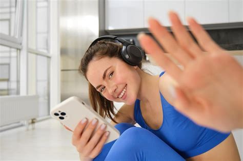 Free Photo Portrait Of Beautiful Brunette Girl Hides From Camera Puts Her Hand Towards Camera