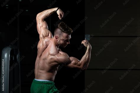 Foto De Bodybuilder Performing Rear Double Biceps Pose Do Stock Adobe Stock
