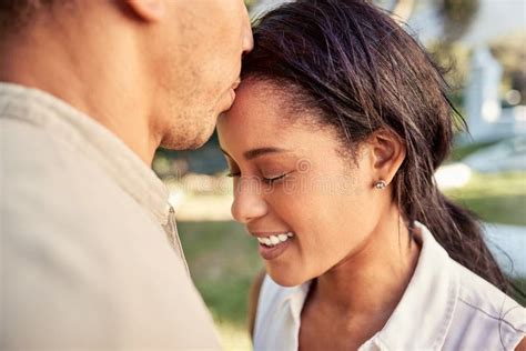 Couple Love And Outdoor Park For Bonding With A Kiss On Forehead Showing Commitment Trust And