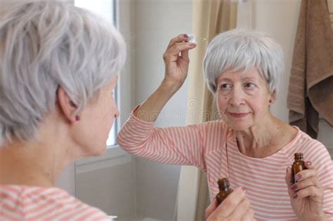 Short Haired Mature Woman Protecting Her Hair With Natural Oils Stock Image Image Of Applying