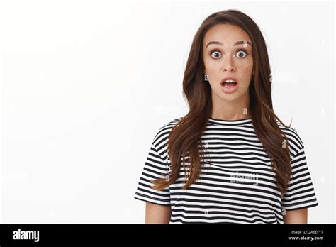 Surprised Speechless Cute Brunette Girl In Striped T Shirt Drop Jaw From Amazement Stare Camera