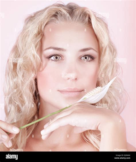 Closeup portrait de belle fille blonde avec une fleur cala isolé sur