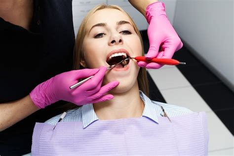 Free Photo Female Dentist Treating Her Patient Teeth