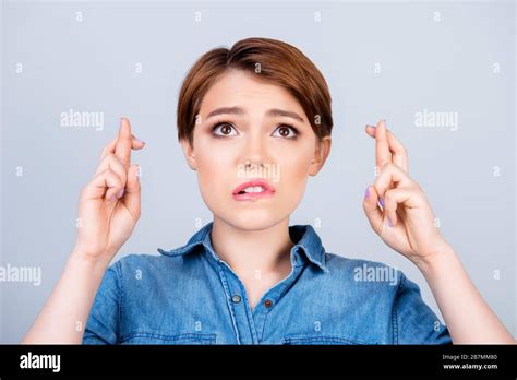 Pretty Young Woman Is Hoping Her Wish Will Come True Waiting With Crossed Fingers On Light Blue
