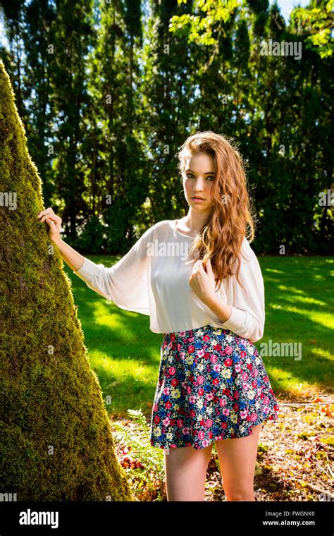 A Beautiful Young Girl Poses For A Fashion Style Portrait Outdoors At A Park With Natural