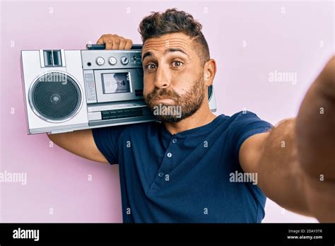 Handsome Man With Beard Holding Boombox Listening To Music Puffing Cheeks With Funny Face