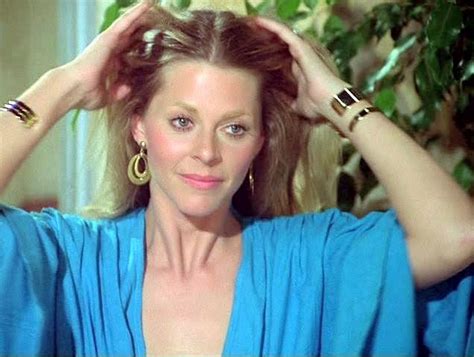 A Woman Is Holding Her Hair In The Air