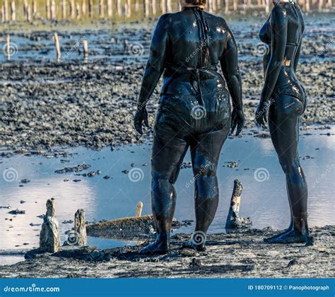 Two Woman After Applying Black Healing Clay Mud Spa On The Shore Of