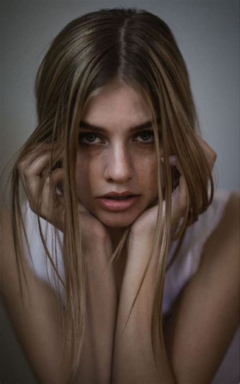 A Woman With Long Hair Posing For The Camera