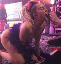 Miley Cyrus Performs Topless With A Strap On And Takes Dollars Up Her Ass