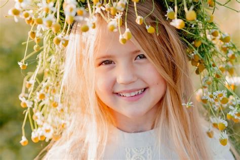 Premium Photo Portrait Of A Little Blonde Girl With A Wreath Of Daisies On Her Head In The
