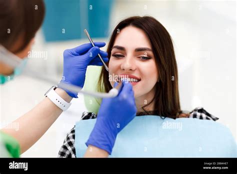 Woman At The Dentistry Dentist Treats Teeth To His Pretty Patient Dental Doctor Drills Patient