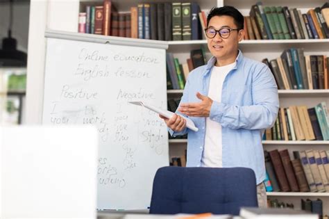 Premium Photo Chinese Teacher Having Online Lecture Standing Near Whiteboard In Classroom
