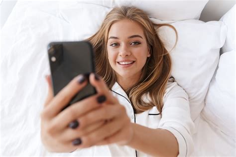 Premium Photo Lovely Cheerful Woman In Pajama Taking Selfie Photo On Cellphone And Smiling