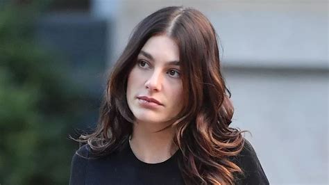 Camila Morrone Shows Off Her Sculpted Midriff In A Black Cropped Top And Jeans As She Strikes A