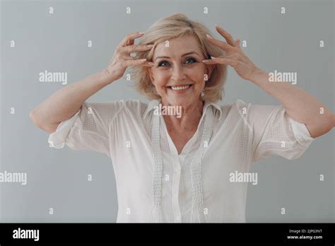 Elderly Caucasian Old Aged Granny Woman Gray Haired Portrait Doing Facebuilding Yoga Face