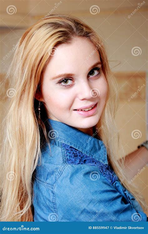 Blonde Standing In Profile Smiling At The Camera Leaning Forward Stock Image Image Of