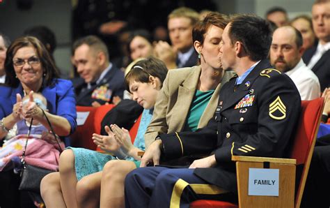 Former Army Staff Sgt Clinton L Romesha Receives A Kiss From His Wife Tamara At The Pentagon