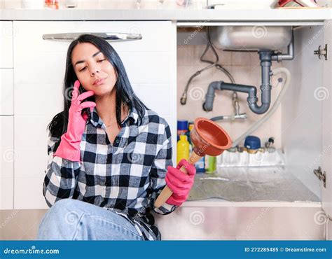 Stressed Housewife Calling A Plumber Service For Assistance After Water Leak Problem At Home