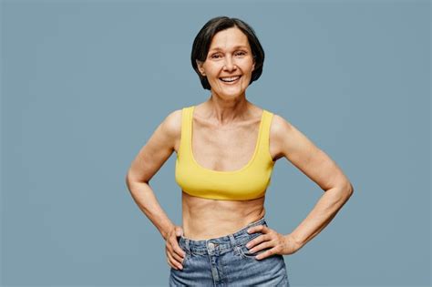 Premium Photo Candid Waist Up Portrait Of Mature Woman Smiling At Camera While Posing Against