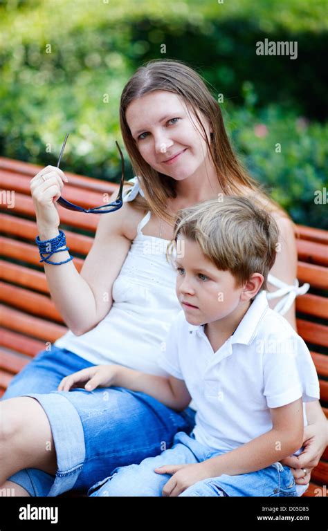 Closeup Of Mother And Son Sitting Outdoors Stock Photo Alamy