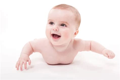 Naked Smiling Baby Lying On His Stomach On A White Background An Stock
