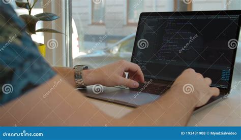 closeup coding on screen man hands coding html and programming on screen laptop development