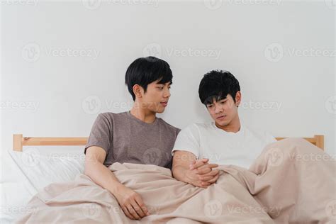 Handsome Asian Gay Couple Talking On Bed At Home Young Asian Lgbtq Guy Happy Relax Rest