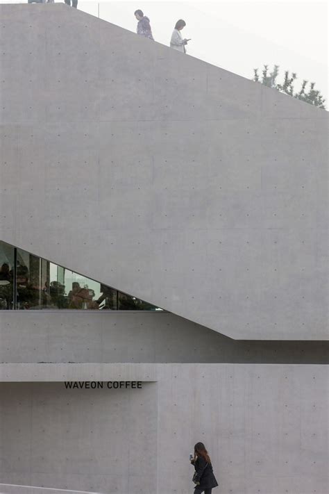stacked concrete blocks and roof deck give diners sea views at south korean cafe