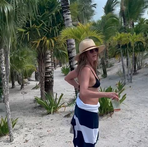 Jennifer Aniston Shows Off Her Fit Figure In A Black Bikini During