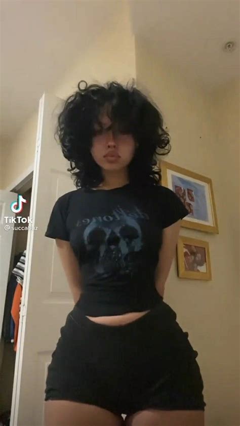 A Woman In Short Shorts And A Black Shirt