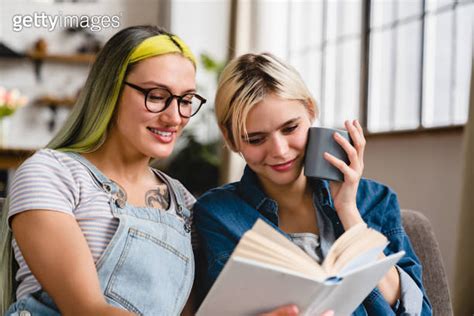 Closeup Portrait Of Two Sisters Girlfriends Lgbtq Couple Lesbians Sitting On The Sofa Relaxing