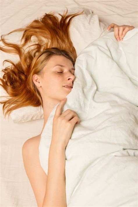 Girl Looks Out From Under The Blanket Funny Woman White Bed Playful Gaze Close Up Stock