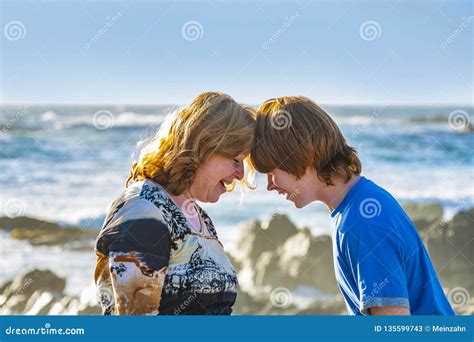 Mother And Son Enjoy The Afternoon Sun At The Beach Stock Image Image