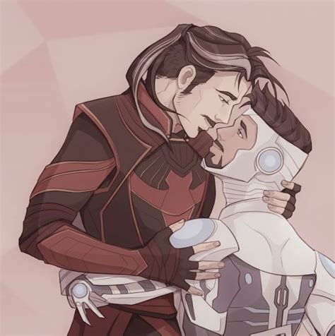 Two People Are Hugging Each Other While One Person Is Holding Something In His Hand And The Other