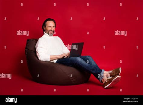 Full Size Photo Of Mature Cheerful Positive Good Mood Man Sit Chair Smiling Work In Laptop
